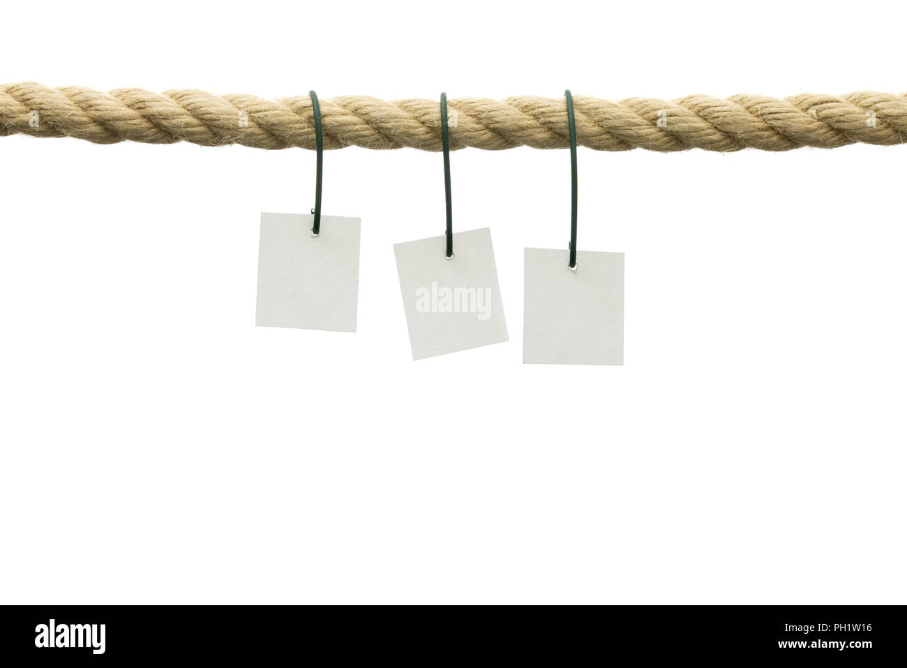Three white blank cards hanging off thick frayed rope, empty space ...