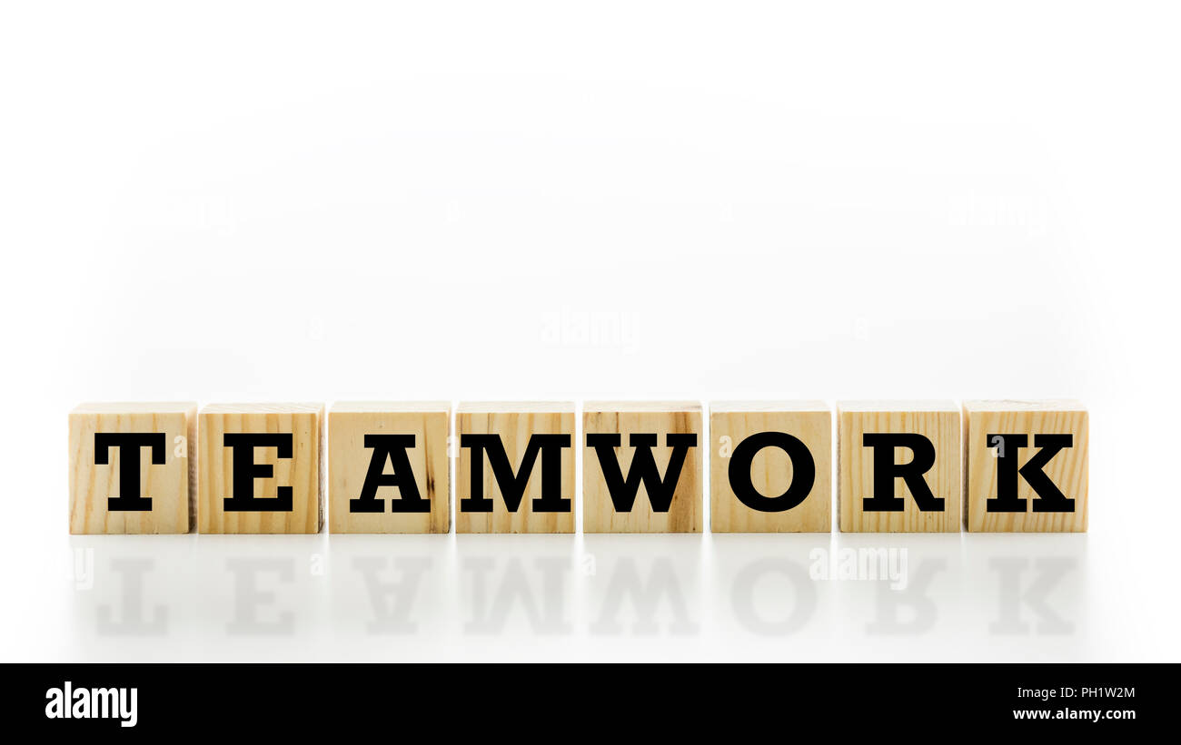 The word Teamwork on wooden cubes arranged in a line over white with ...