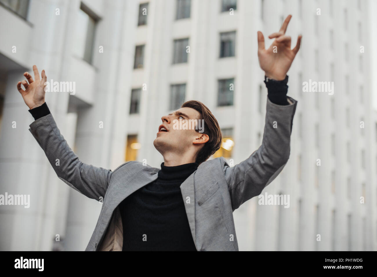 Smiling man dancing raising arms hi-res stock photography and images ...