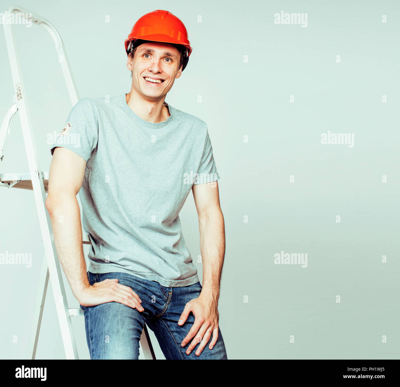 young real hard worker man isolated on white background on ladde Stock ...