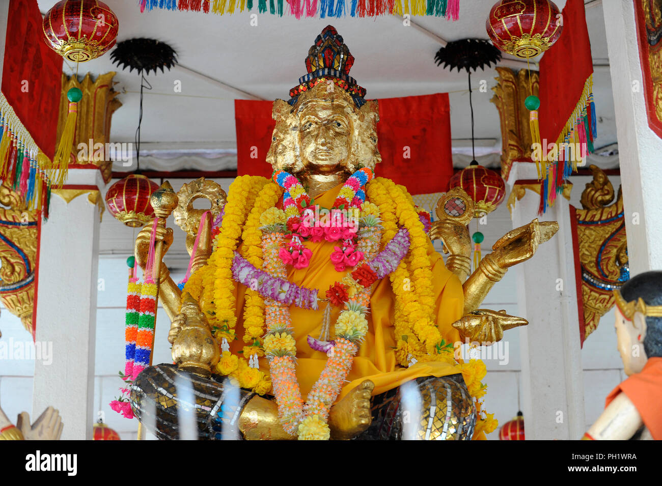 A multi-headed, four face Siamese god statue located in Penang ...