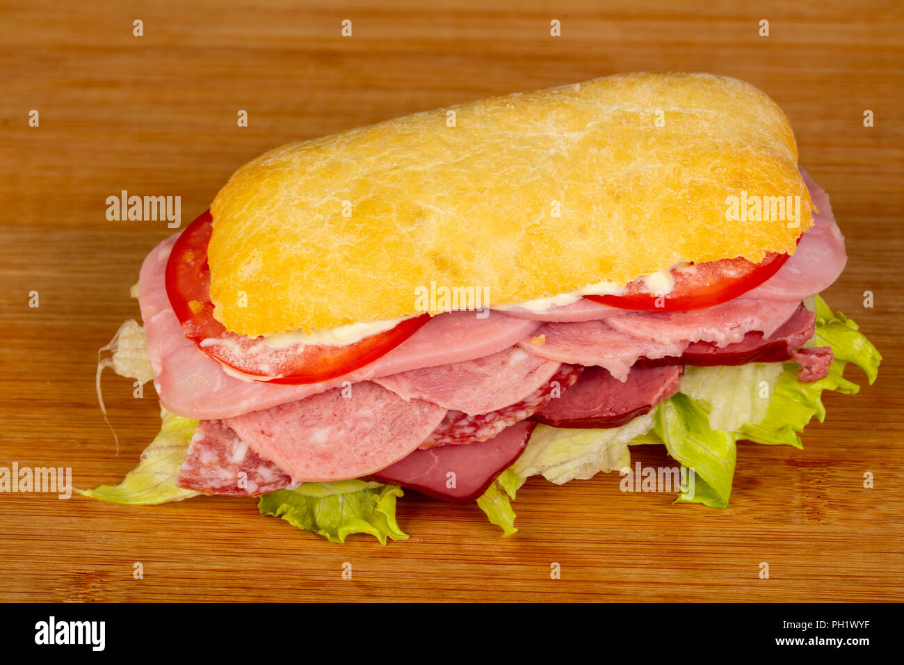 Panini with ham, tomato and sausage Stock Photo - Alamy