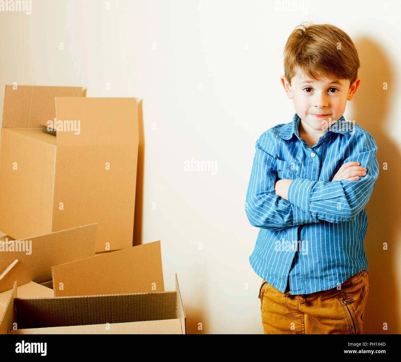 little cute boy in empty room, remoove to new house. home alone Stock ...
