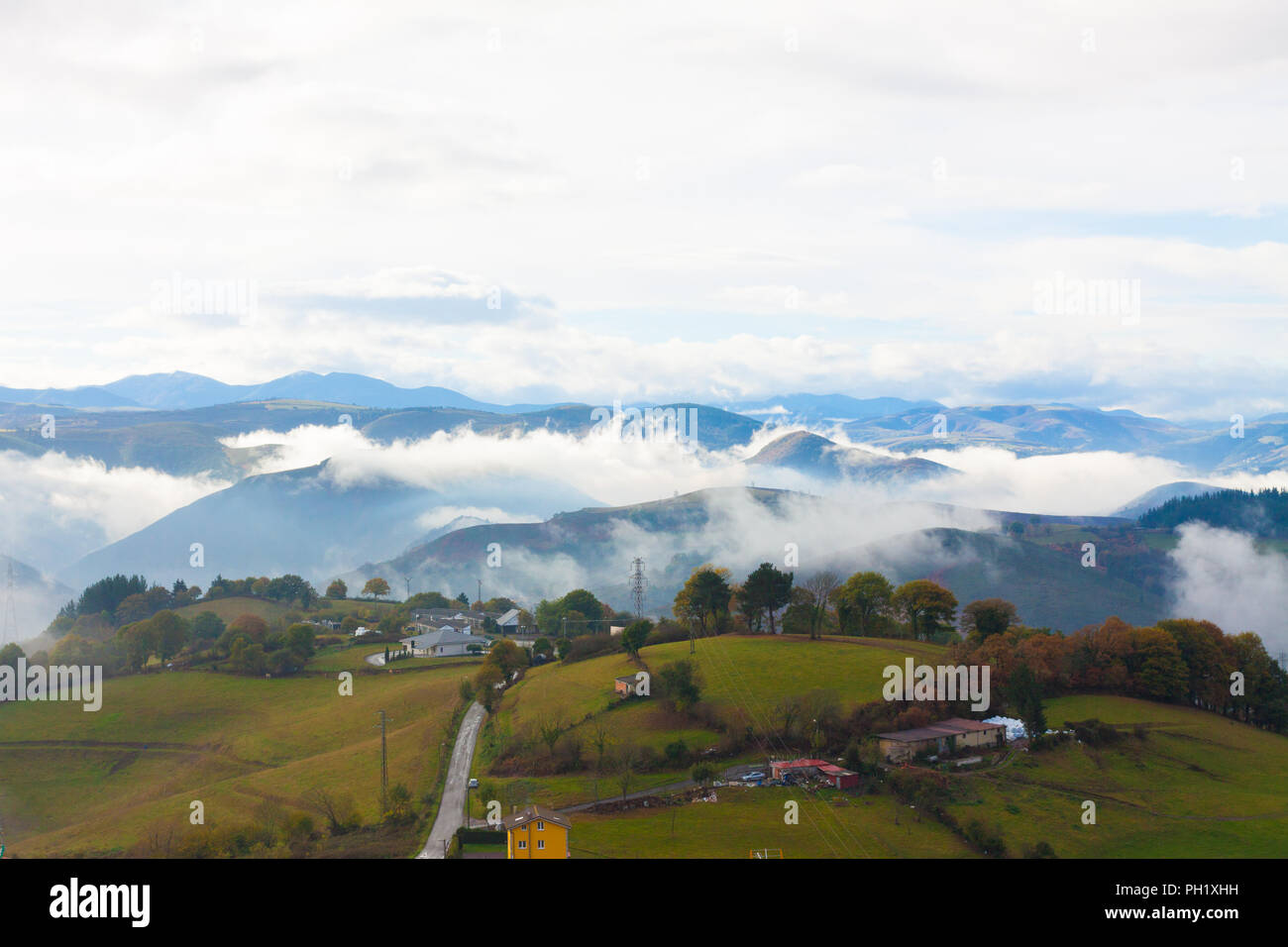 Green hills and foggy mountains in Tineo, Asturias, Spain Stock Photo ...