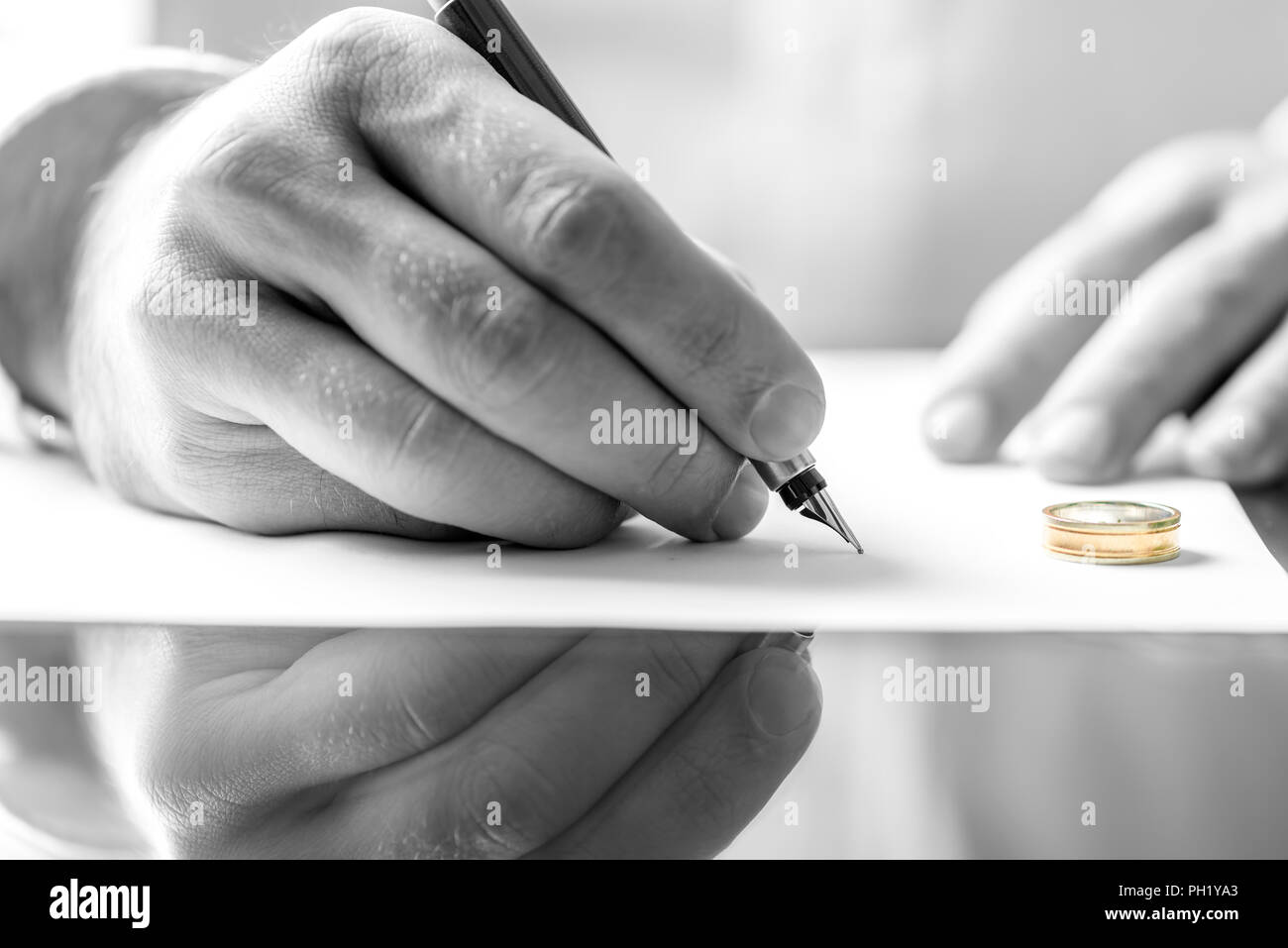 Closeup of male hand signing divorce papers Stock Photo - Alamy
