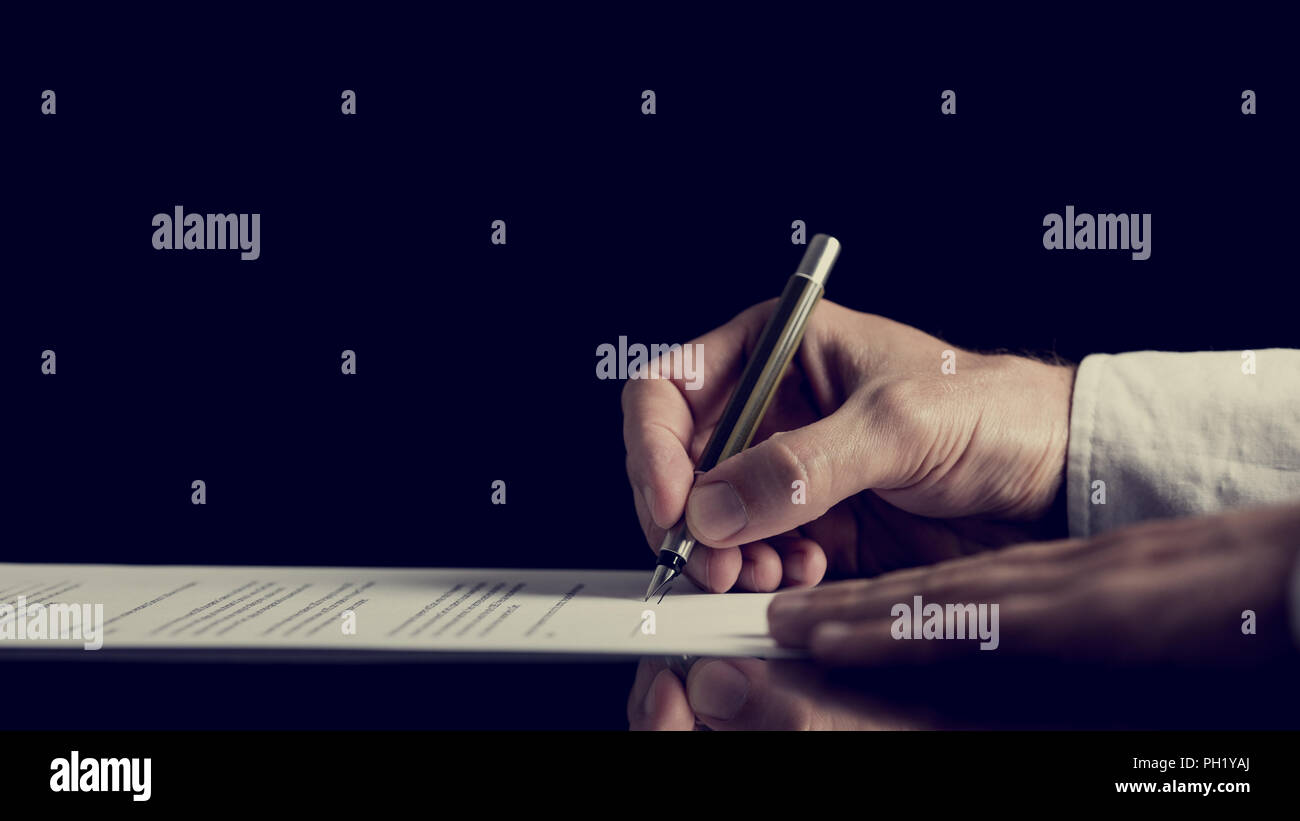 Retro image of a man signing a contract over dark background Stock ...