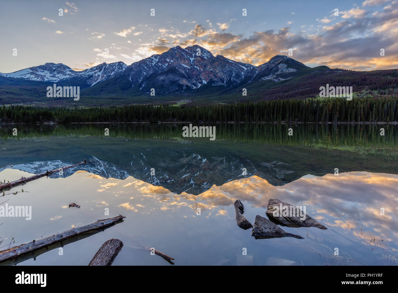 Pyramid Mountain is perfectly reflected in Pyramid Lake in the evening ...