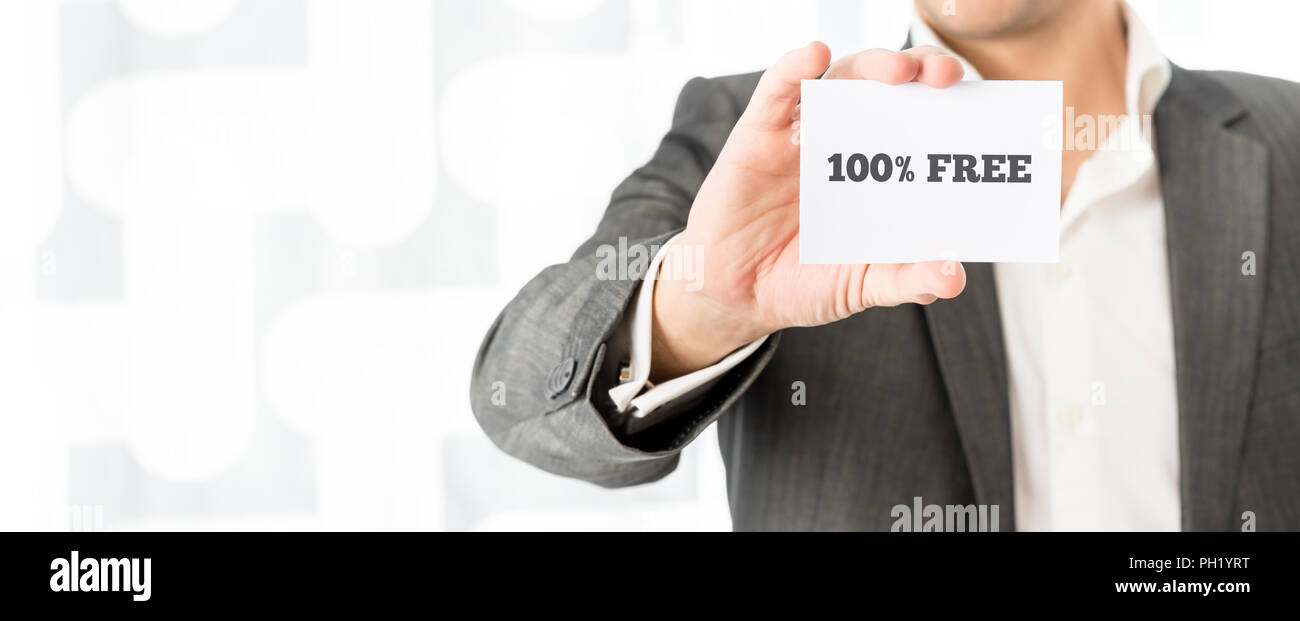 Closeup of salesman showing a white business card with 100% free sign ...