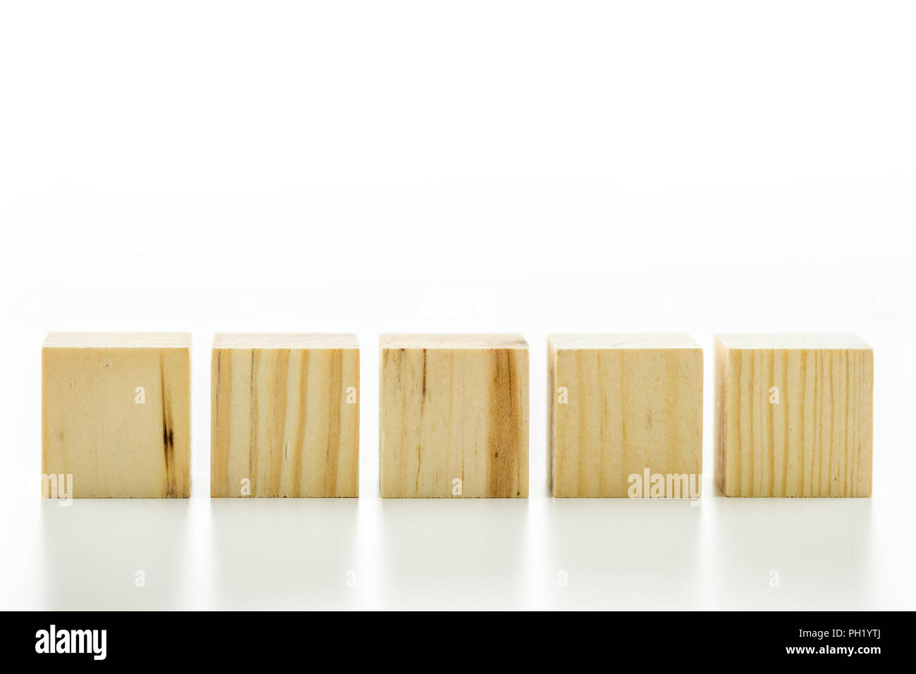 Row of five blank wooden blocks on a white background with copyspace ...