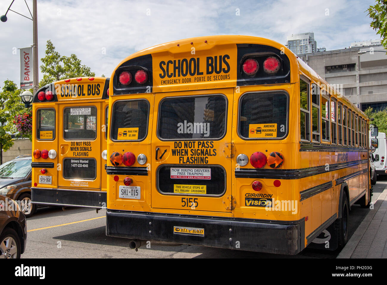 TORONTO, CANADA - AUG 14 2018: Two school buses in traffic in downtown ...