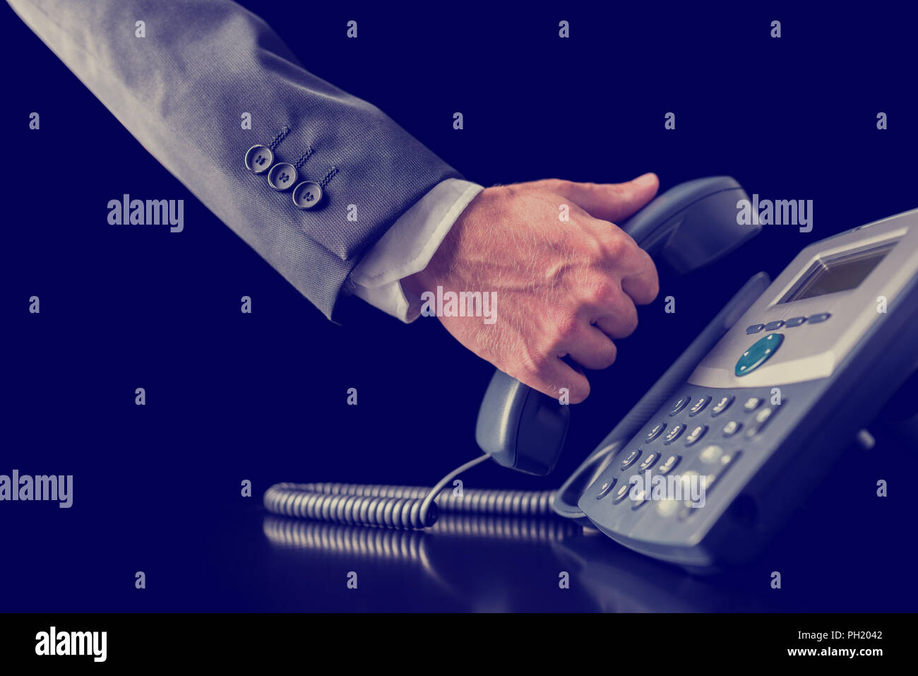 Retro image of businessman making a phone call holding the handset ...