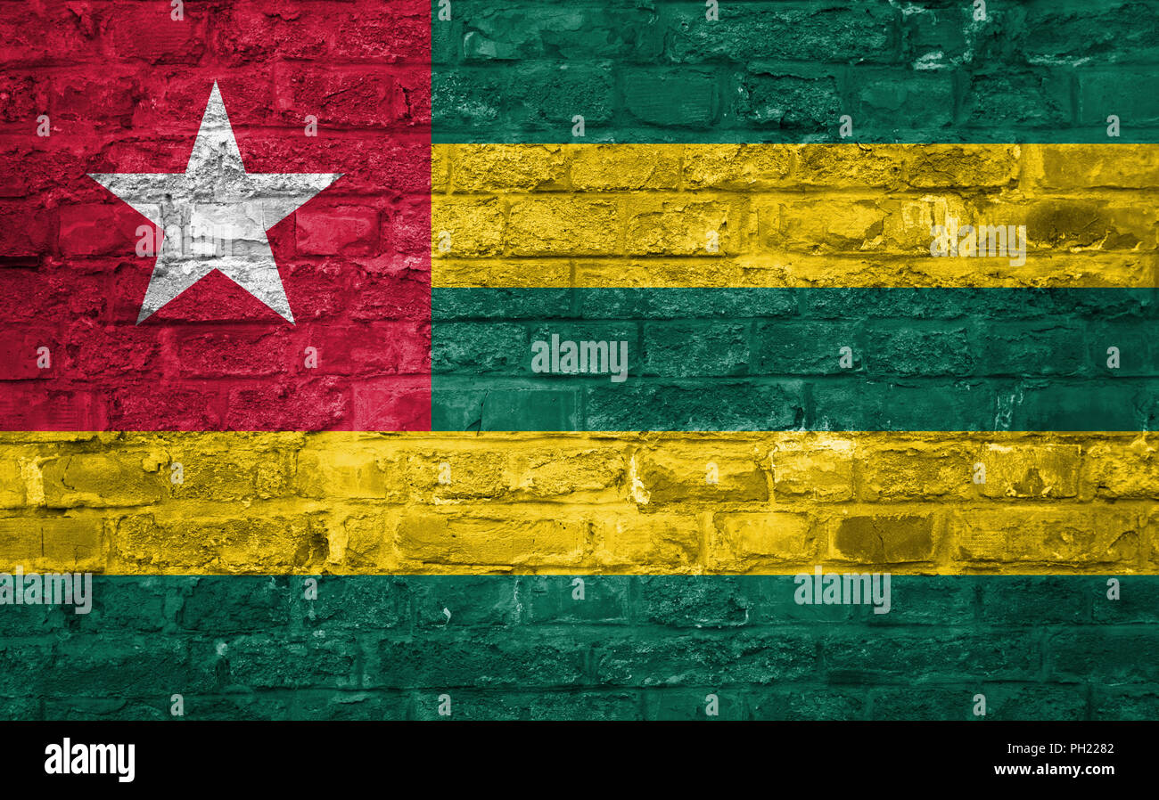 Flag of Togo over an old brick wall background, surface Stock Photo - Alamy