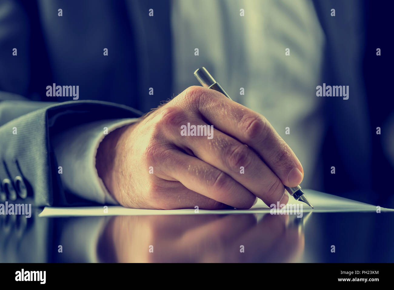 Man signing a document or writing correspondence with a close up view ...