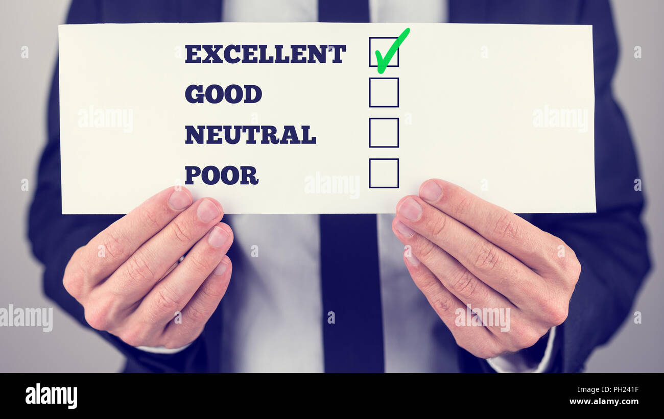 Businessman in a suit holding a survey check with multiple choice check ...