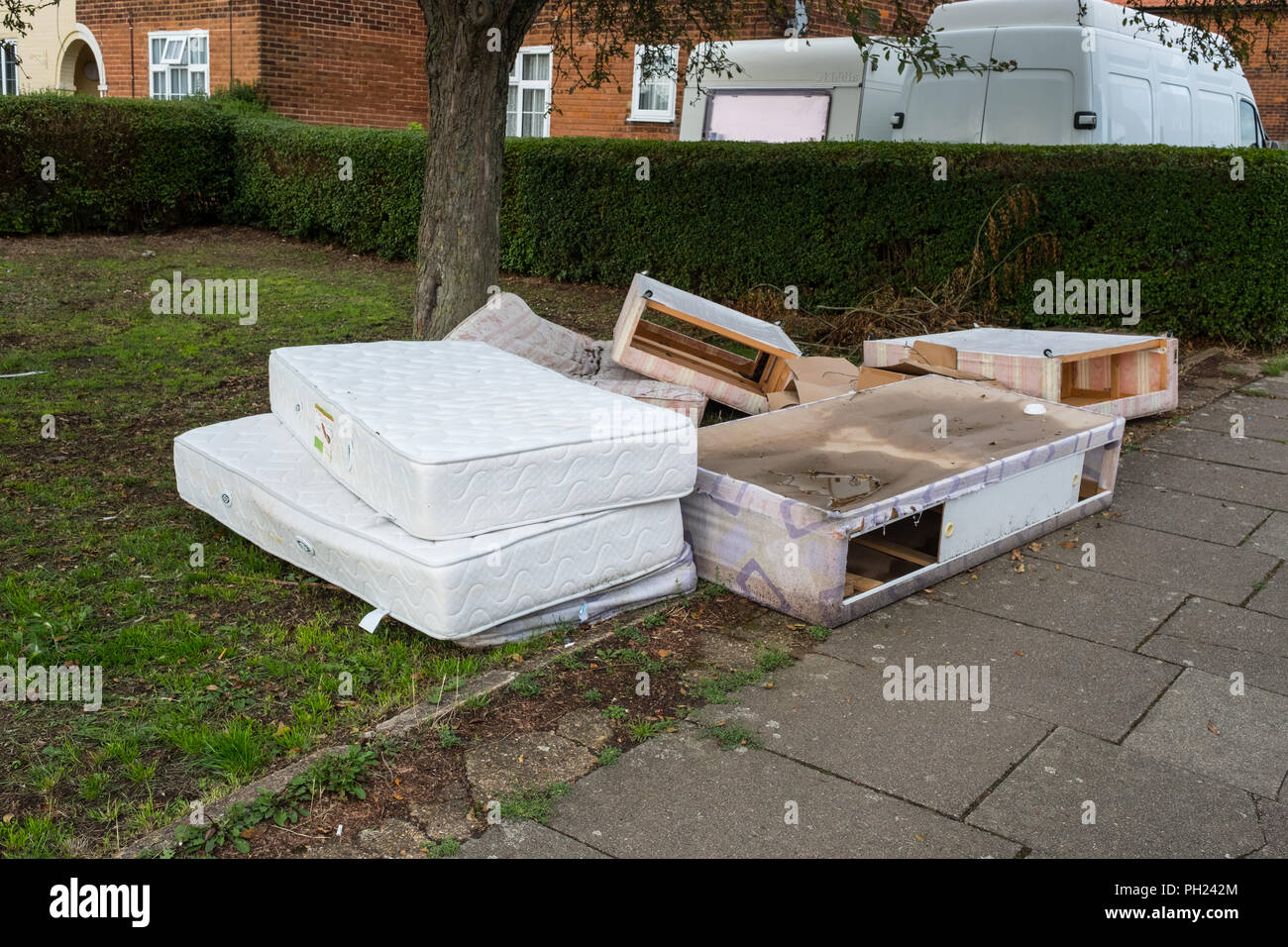 Beds and Mattresses dumped on a road corner in North London Stock Photo ...