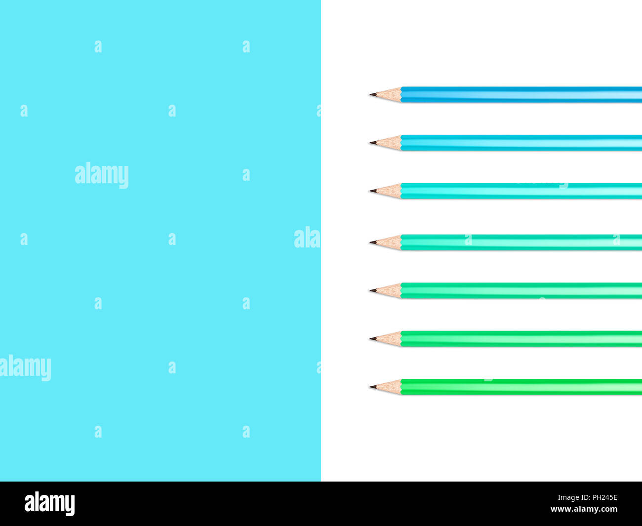 Many different graphite pencils are lying on two-tone background ...