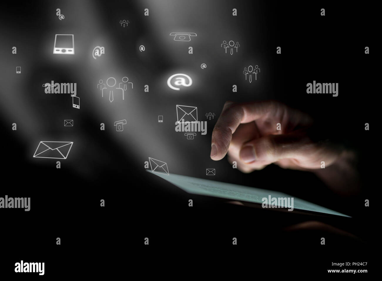 Male hand hovers over digital tablet, illuminated by screen. White ...