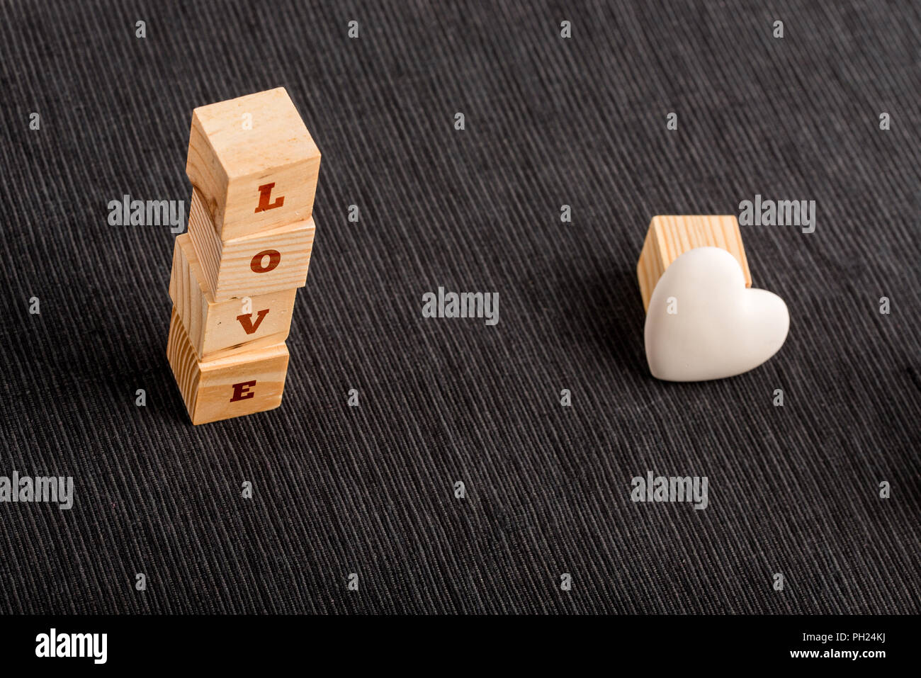 Letter Blocks Stacked Vertically to Spell LOVE Beside Small White Heart ...