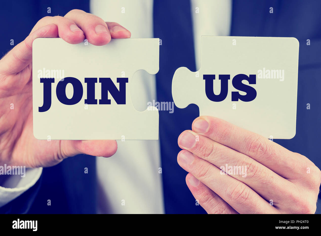 Retro image of male hand holding words Join us split over two puzzle ...