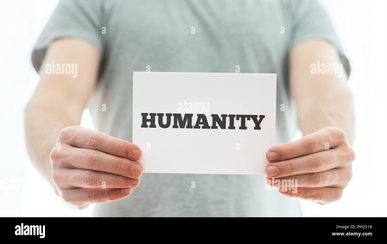 Closeup of a man holding white card with Humanity sign on it Stock ...