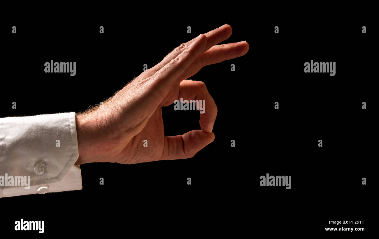 Close up Adult Human Hand in Okay Hand Sign Isolated on Black ...