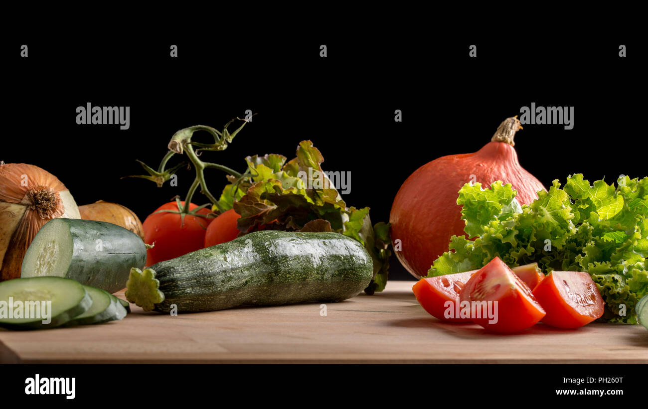 Fresh fruit and vegetables on a wooden kitchen counter with tomato ...