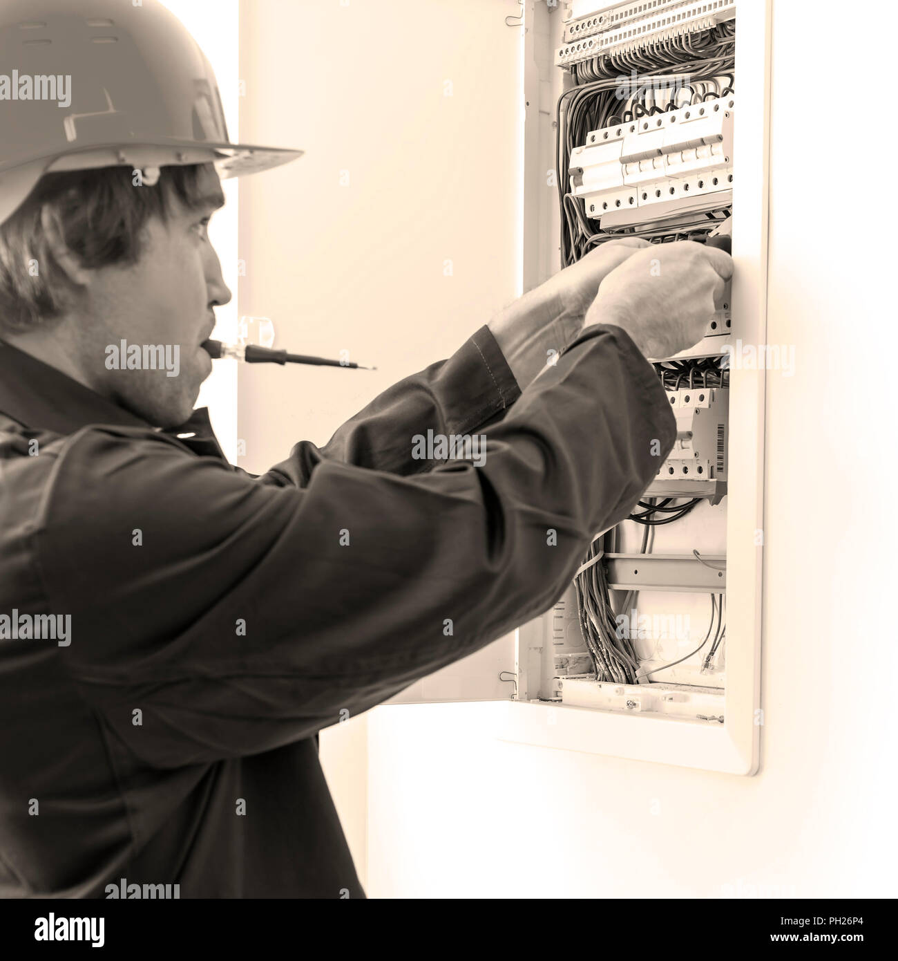 Electrician checking fuse box Stock Photo - Alamy