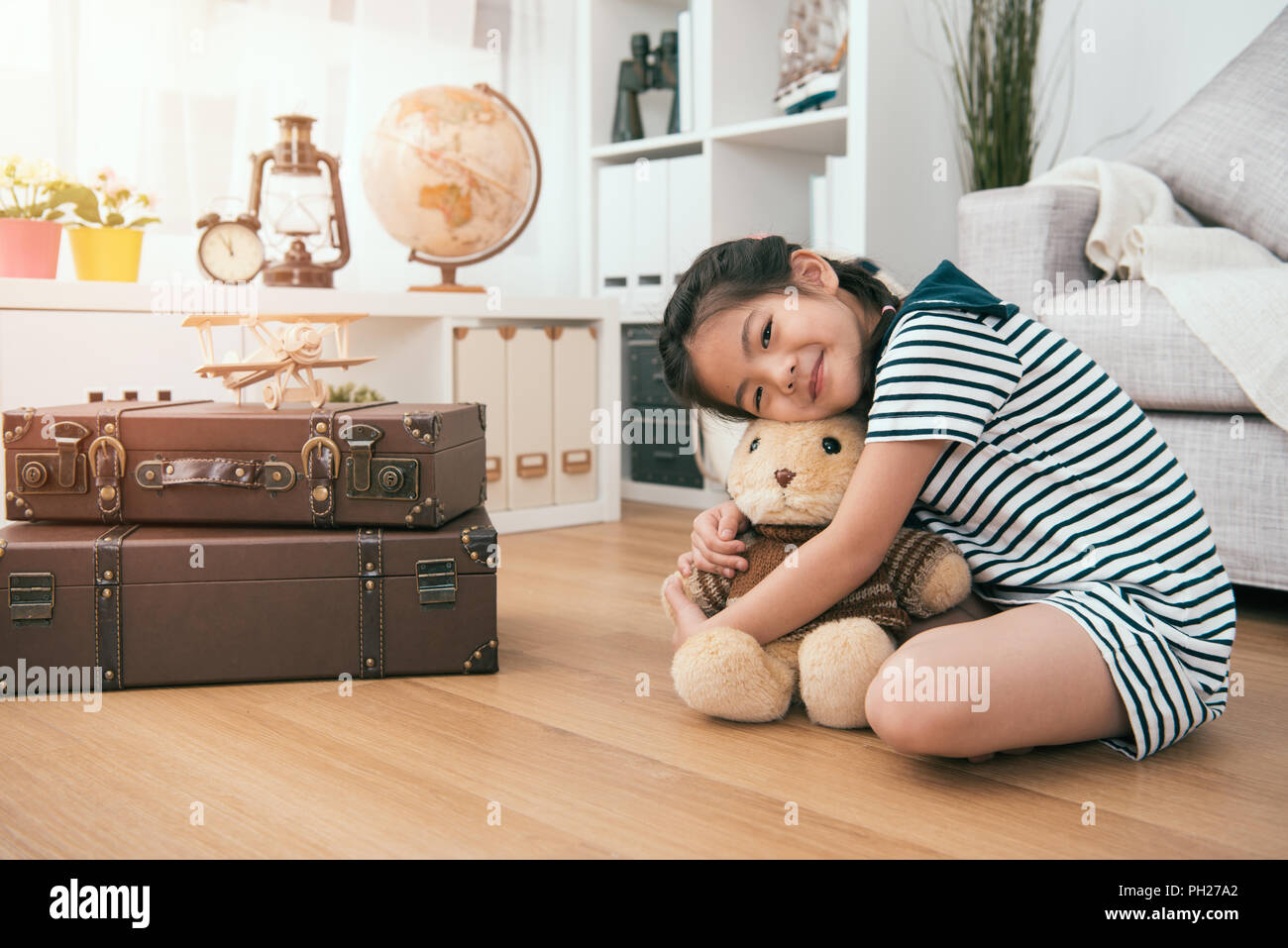 kid hugging her favorite toy. smiling happily with her little friend ...