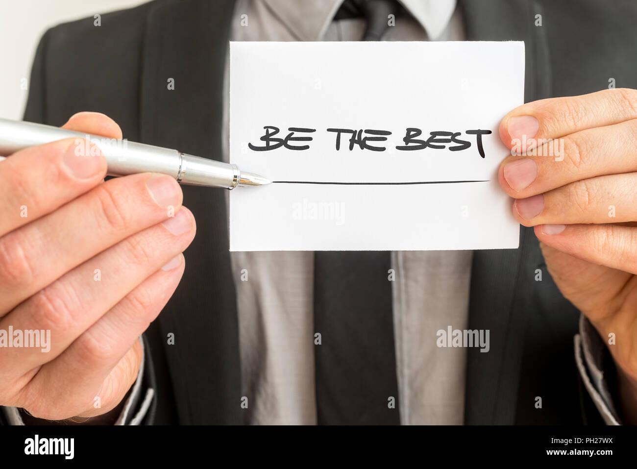 Closeup of personal therapist showing a white card with a Be the best ...