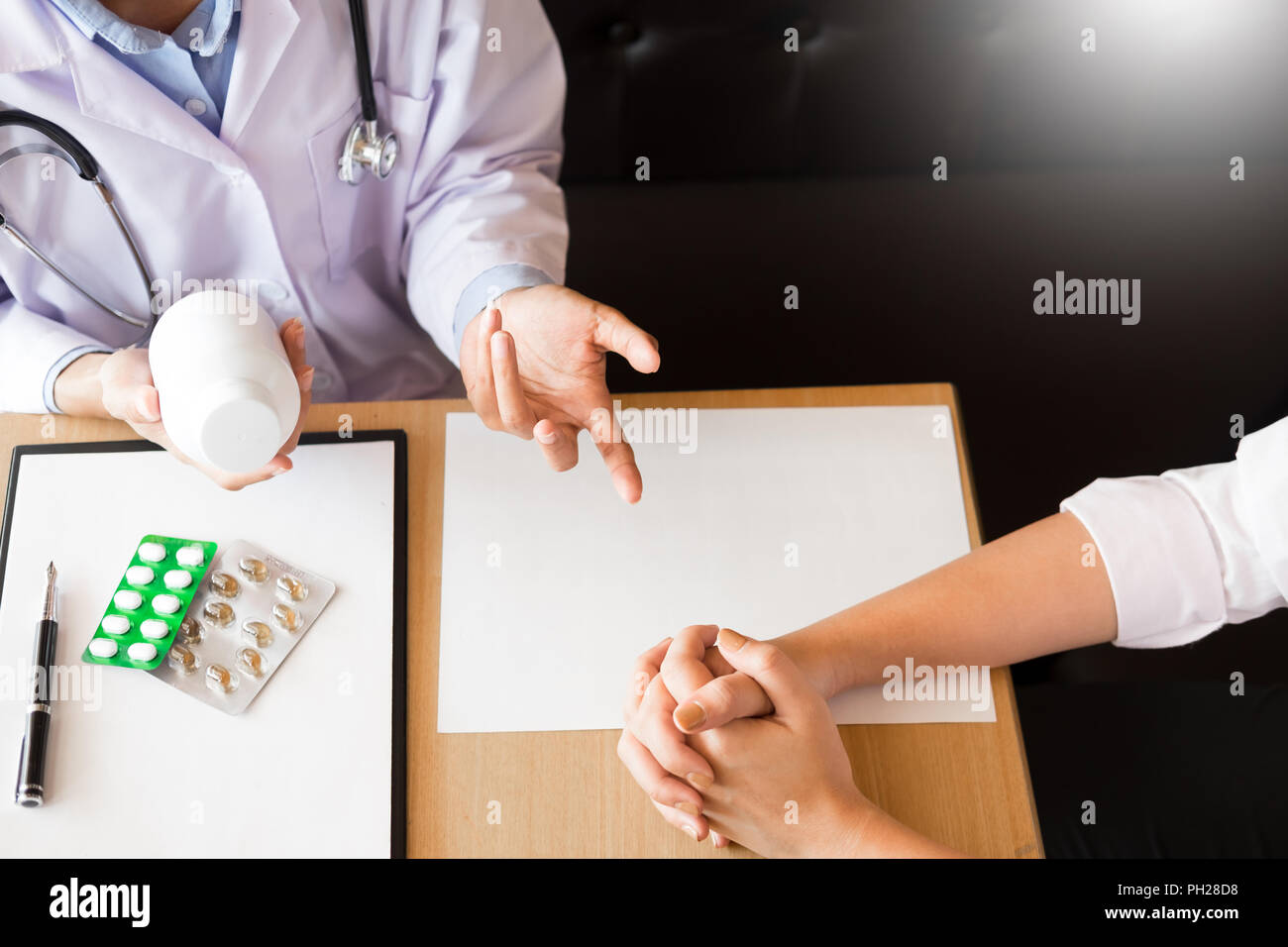 doctor hand holding tablet of drug and explain to patient in hospital ...