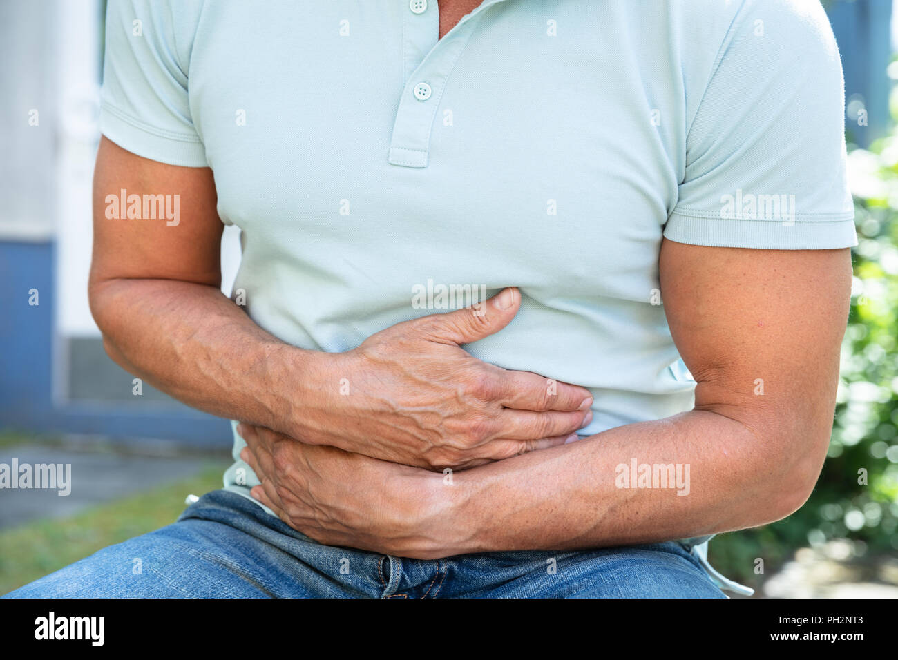Midsection View Of A Man Having Stomach Pain Stock Photo - Alamy