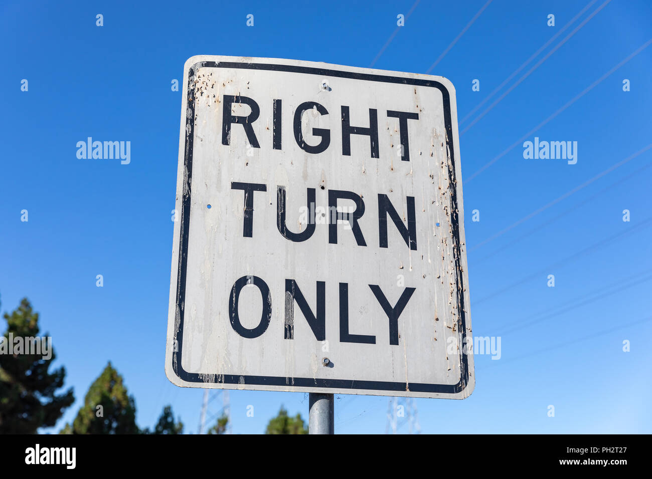 "Right turn only" sign, dirty, against a blue sky Stock Photo - Alamy