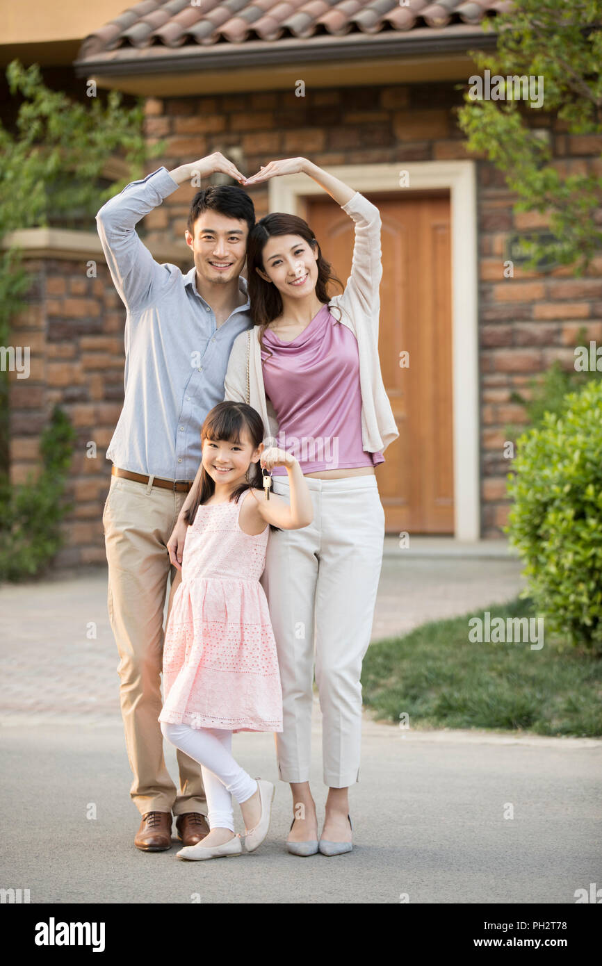 Happy young family holding keys to new house Stock Photo - Alamy