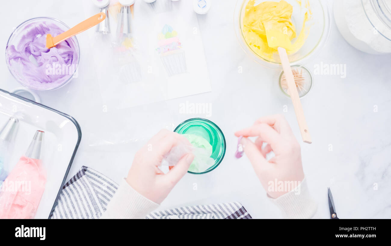 Step by step. Preparing piping bags with colorful buttercream frosting ...