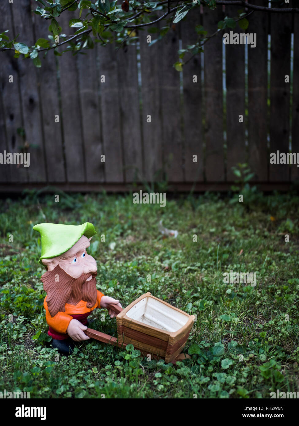 Garden gnome working in the courtyard Stock Photo - Alamy