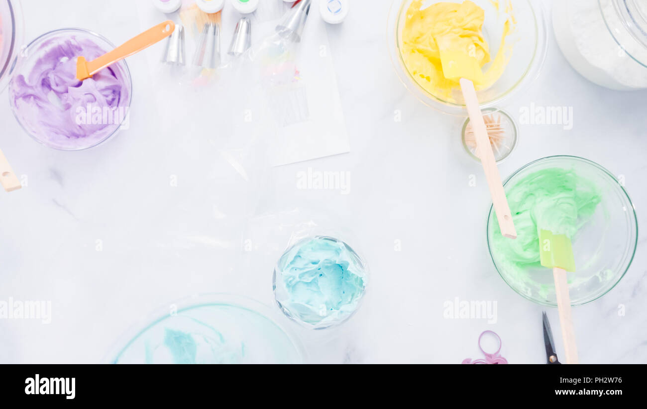 Step by step. Preparing piping bags with colorful buttercream frosting ...