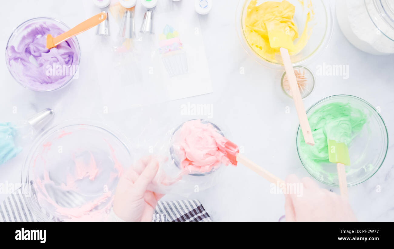 Step by step. Preparing piping bags with colorful buttercream frosting ...