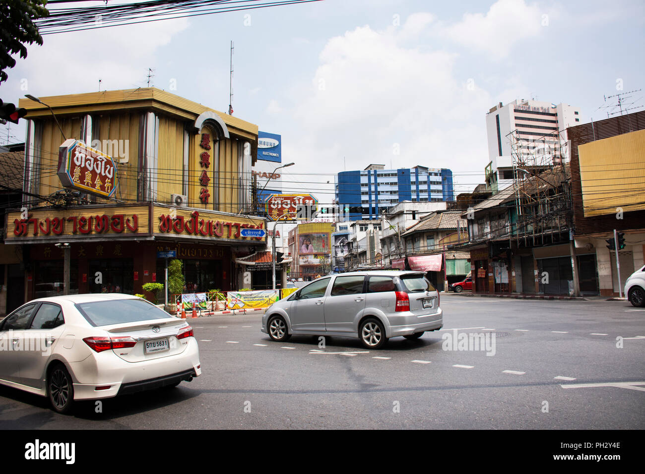 Thai people driving car and riding motorcycle on Yaowarat Road with ...