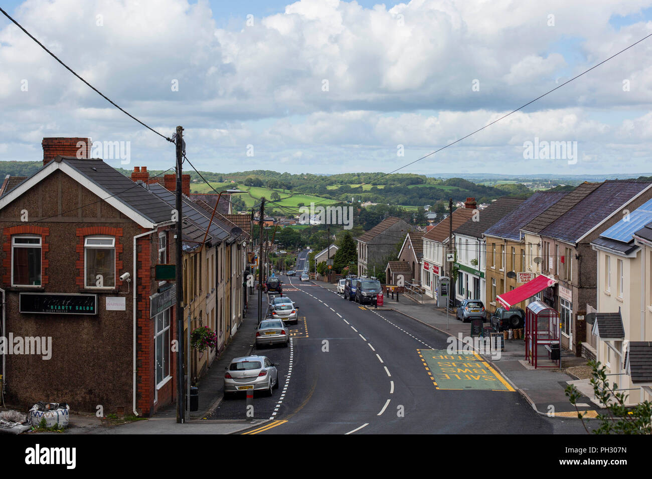 The sloping main street in the town of Tumble, Carmarthenshire Stock ...