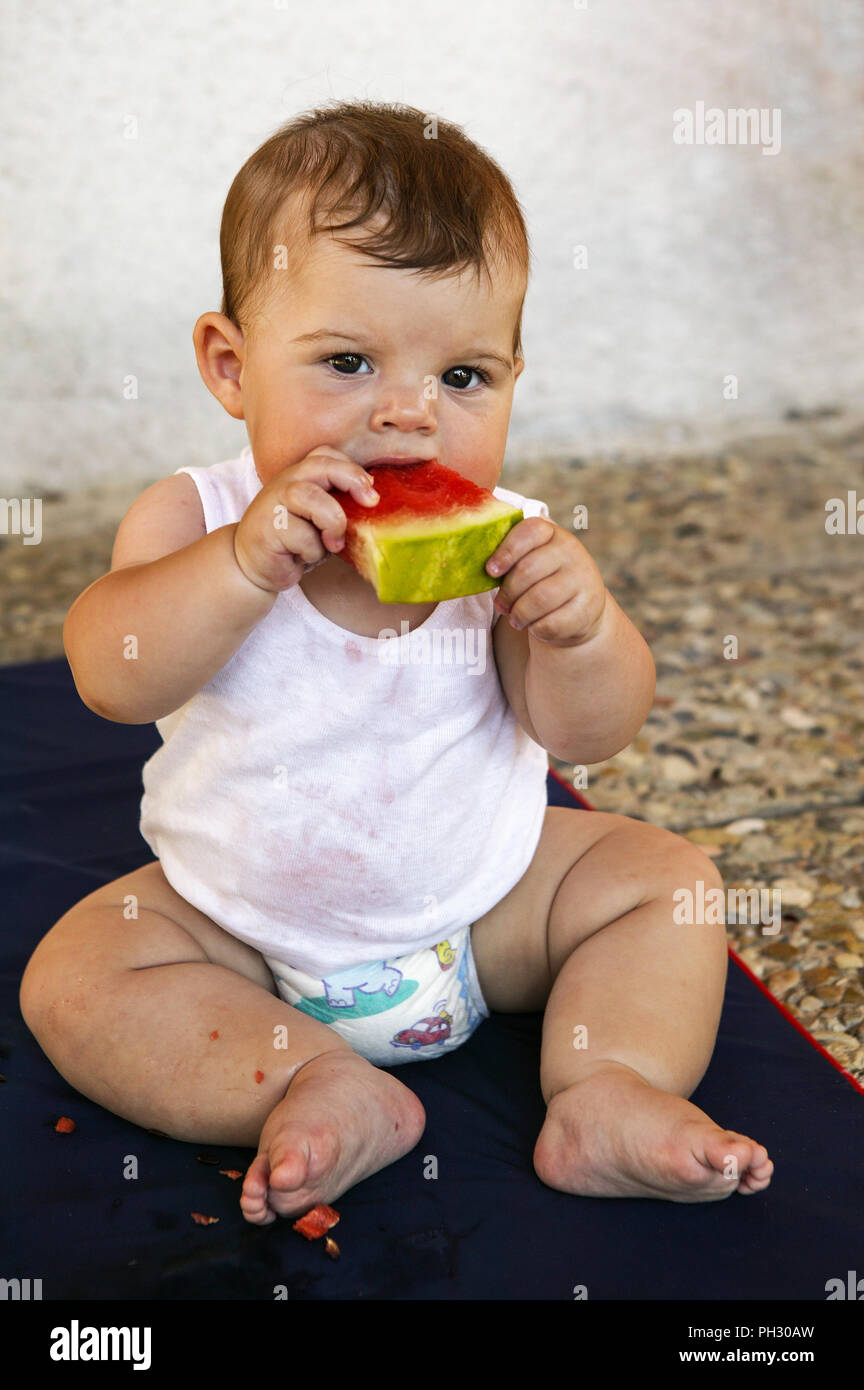 Baby eating watermelon. Italy, Europe Stock Photo - Alamy