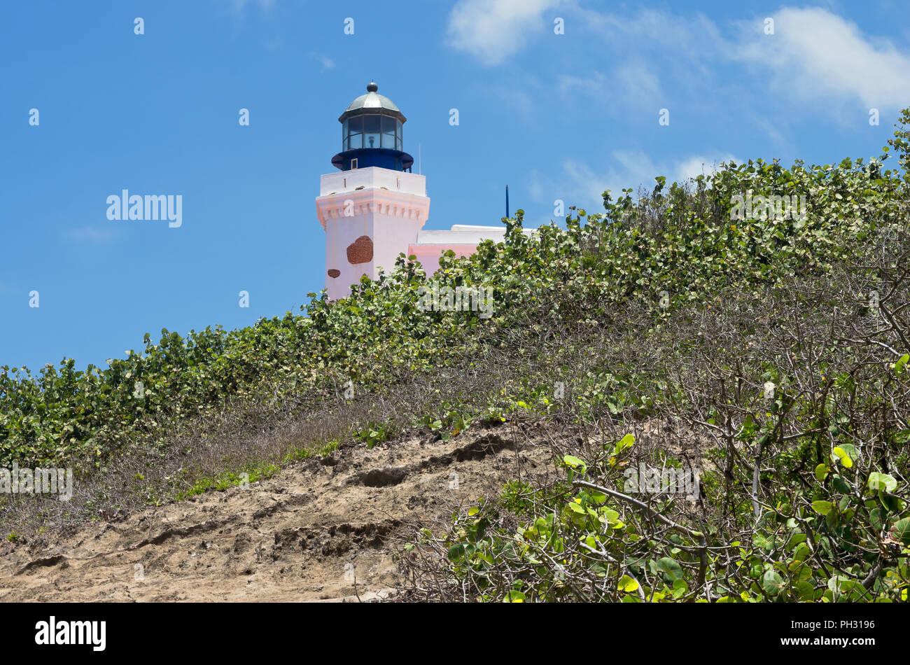 historic lighthouse atop coastal headlands against blue sky arecibo ...