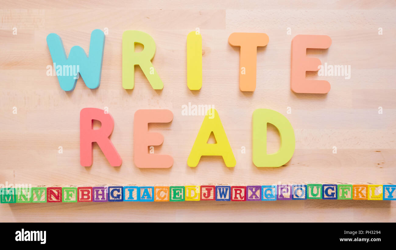 Words READ and WRITE from multicolor wooden letters on wooden table ...