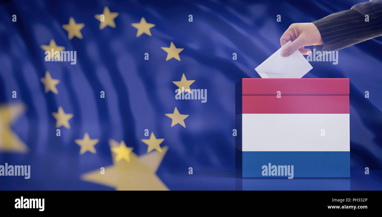 Elections in Netherlands for EU parliament. Hand inserting an envelope ...