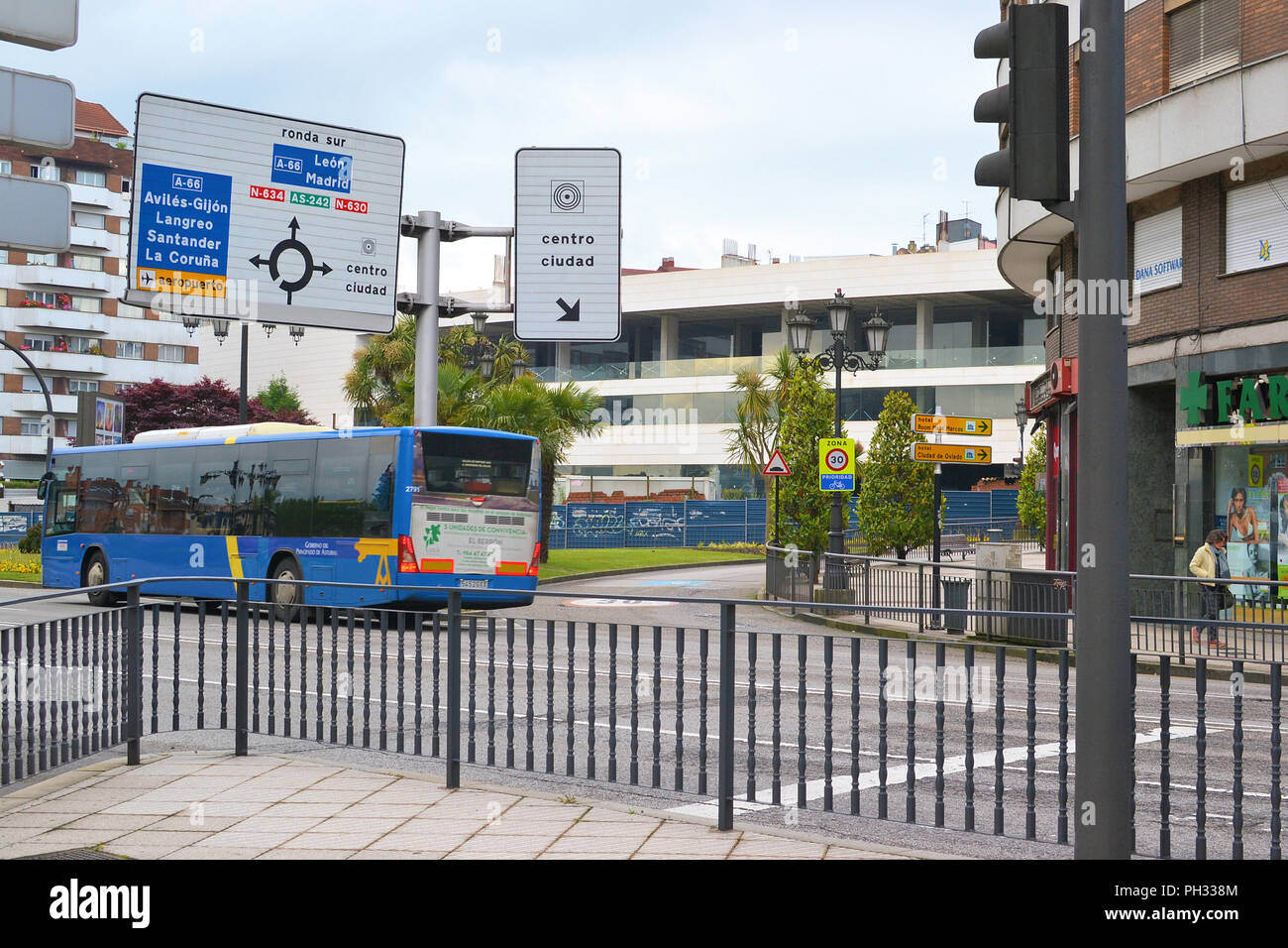 Signs at a roundabout in Oviedo, Spain pointing to different roads ...