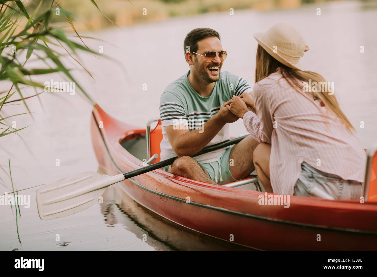Loving couple rowing on the lake at summer day Stock Photo - Alamy