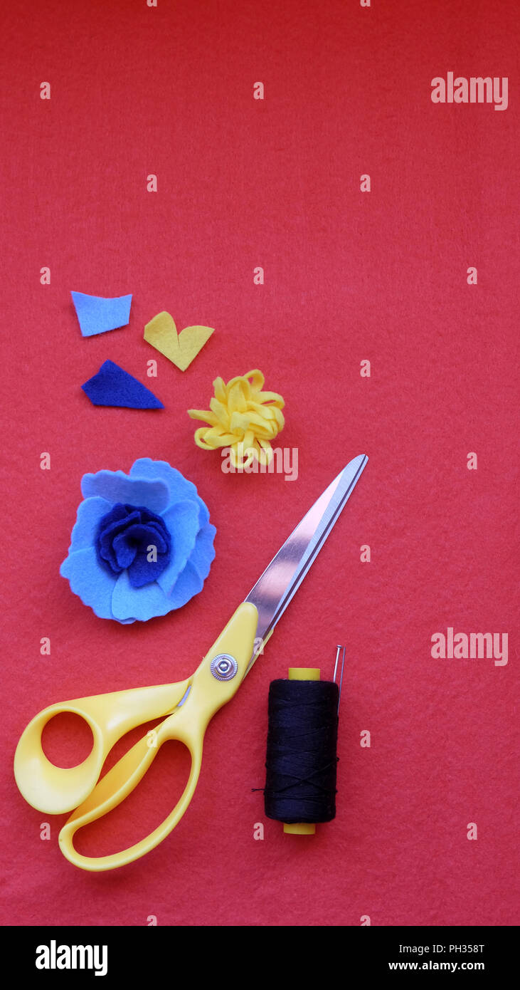 Flat lay felt pieces and craft felt flowers, with sewing kits of ...
