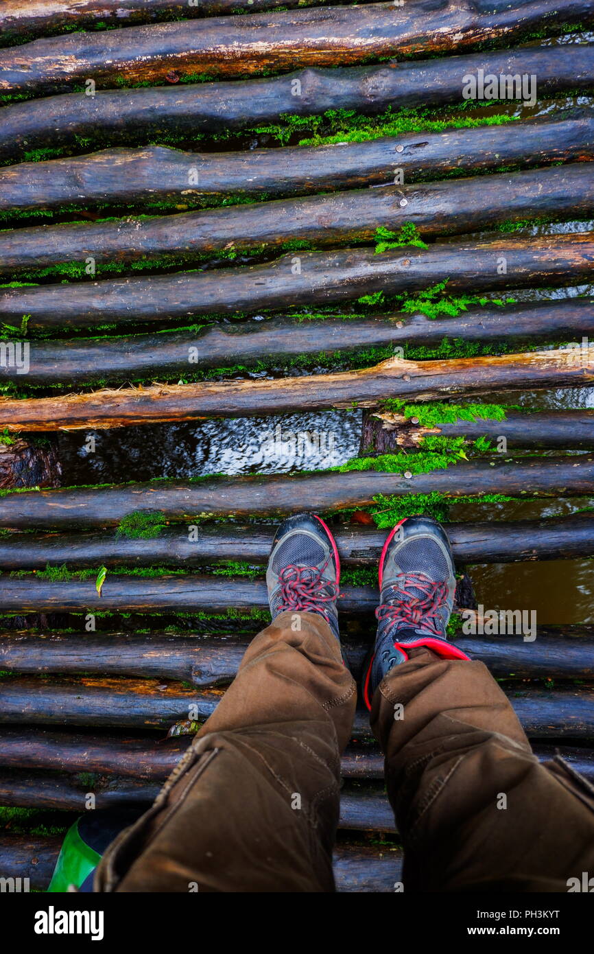 legs of hiker men walking on old wood bridge Stock Photo - Alamy