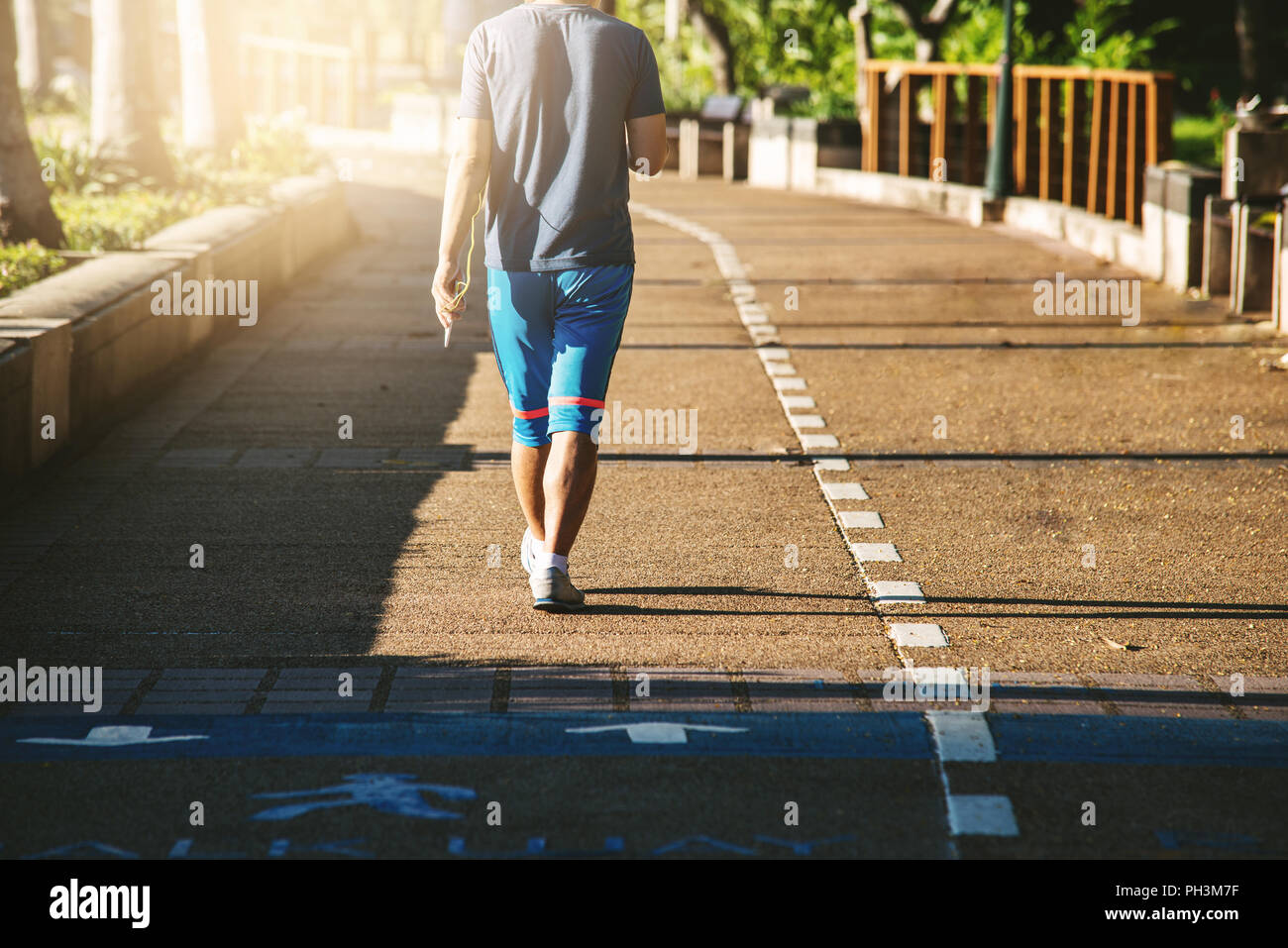 A man walking exercise at the park in the morning Stock Photo - Alamy
