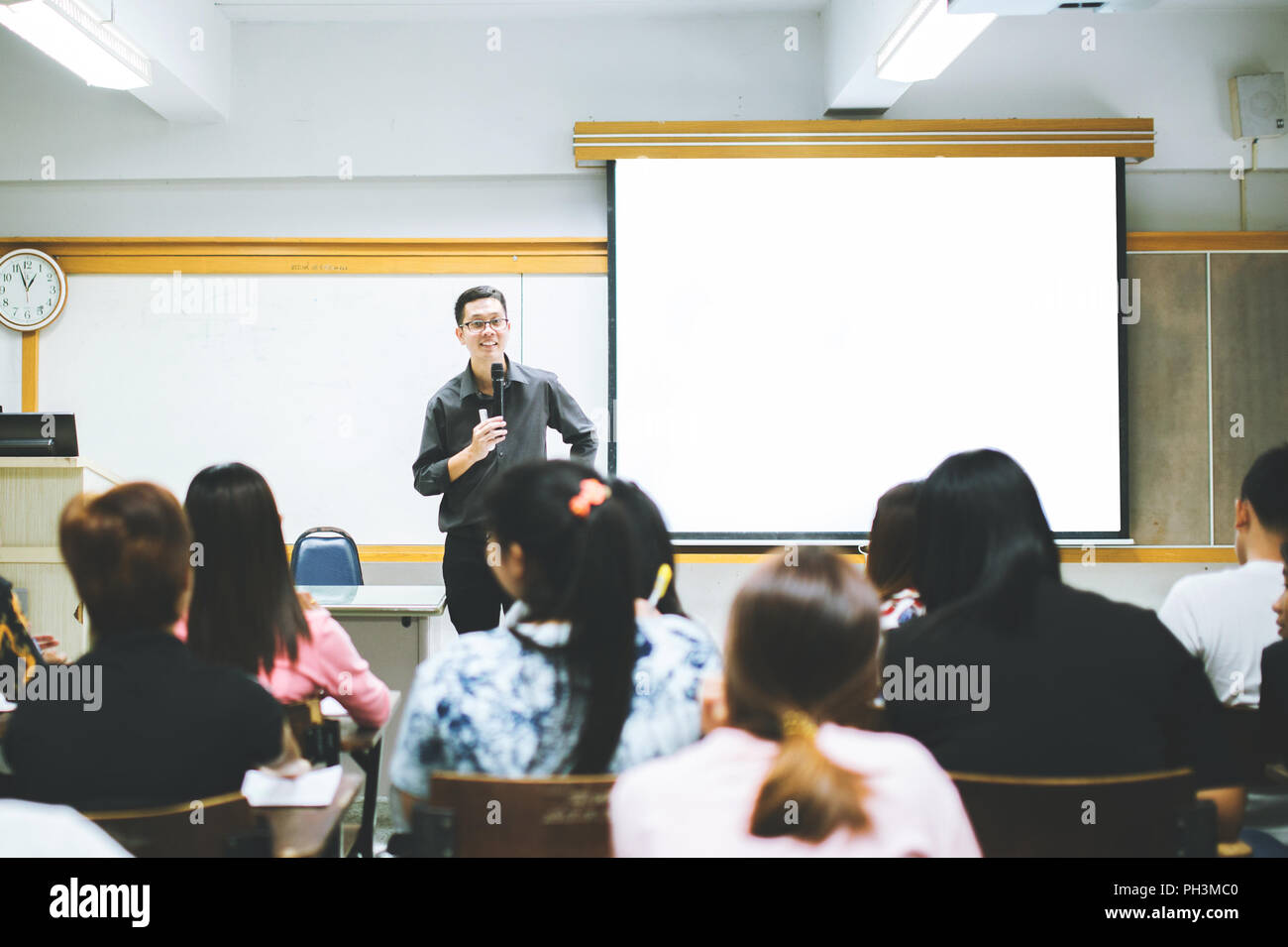 Teacher teaching studen in classroom at university Stock Photo - Alamy