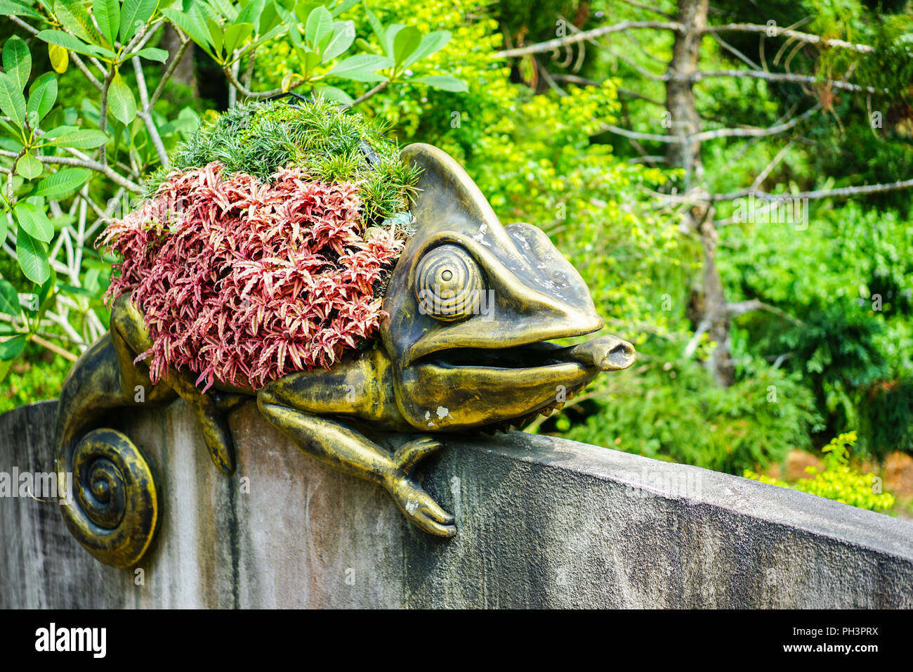 A chameleon bronze statue with a flower on its back decorated in Taipei ...